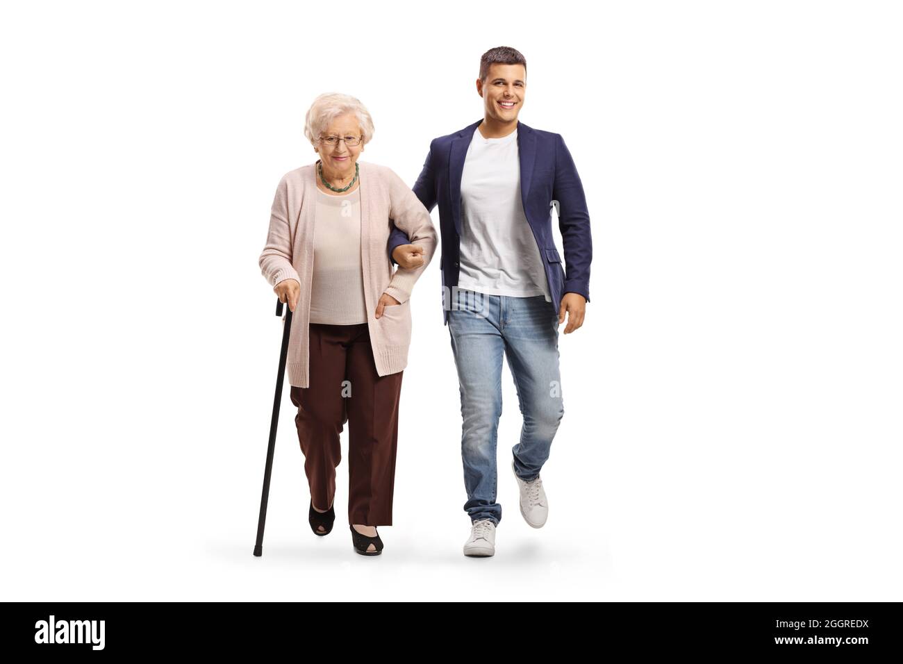 Full length portrait of a young smiling man helping an elderly lady ...
