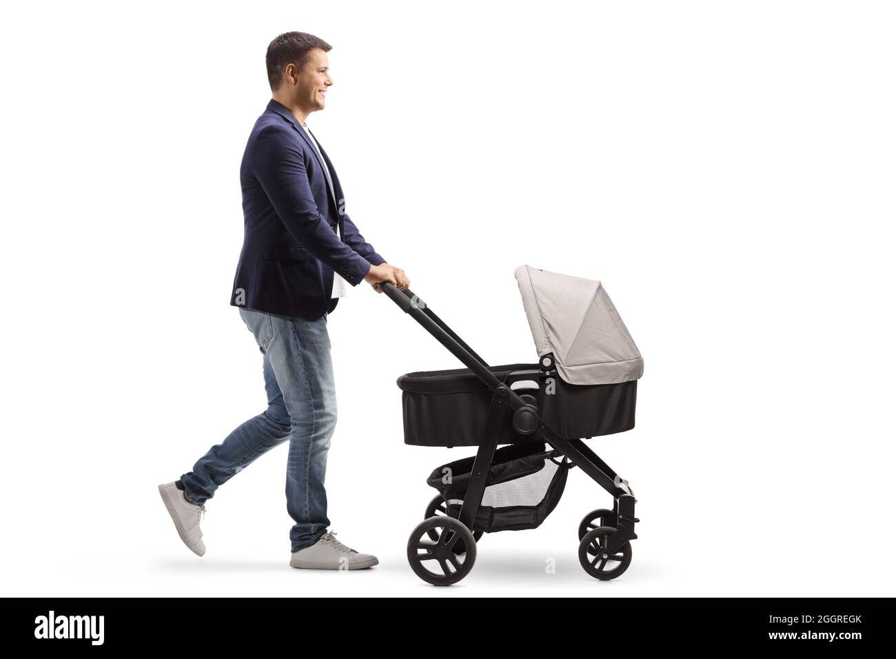 Full length profile shot of a happy father pushing a stroller isolated ...