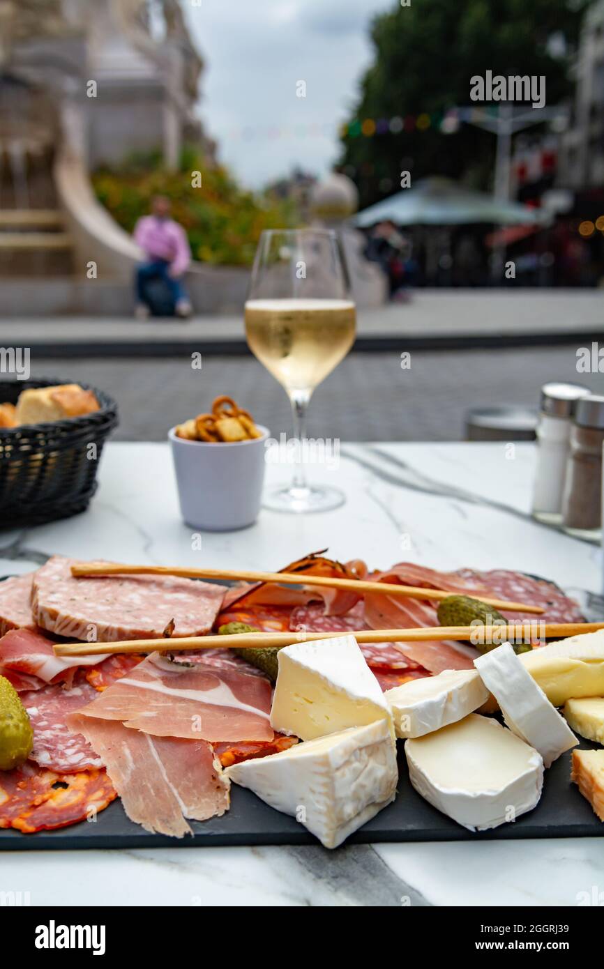 Lunch with glass of brut champagne sparkling wine and meat and cheese ...