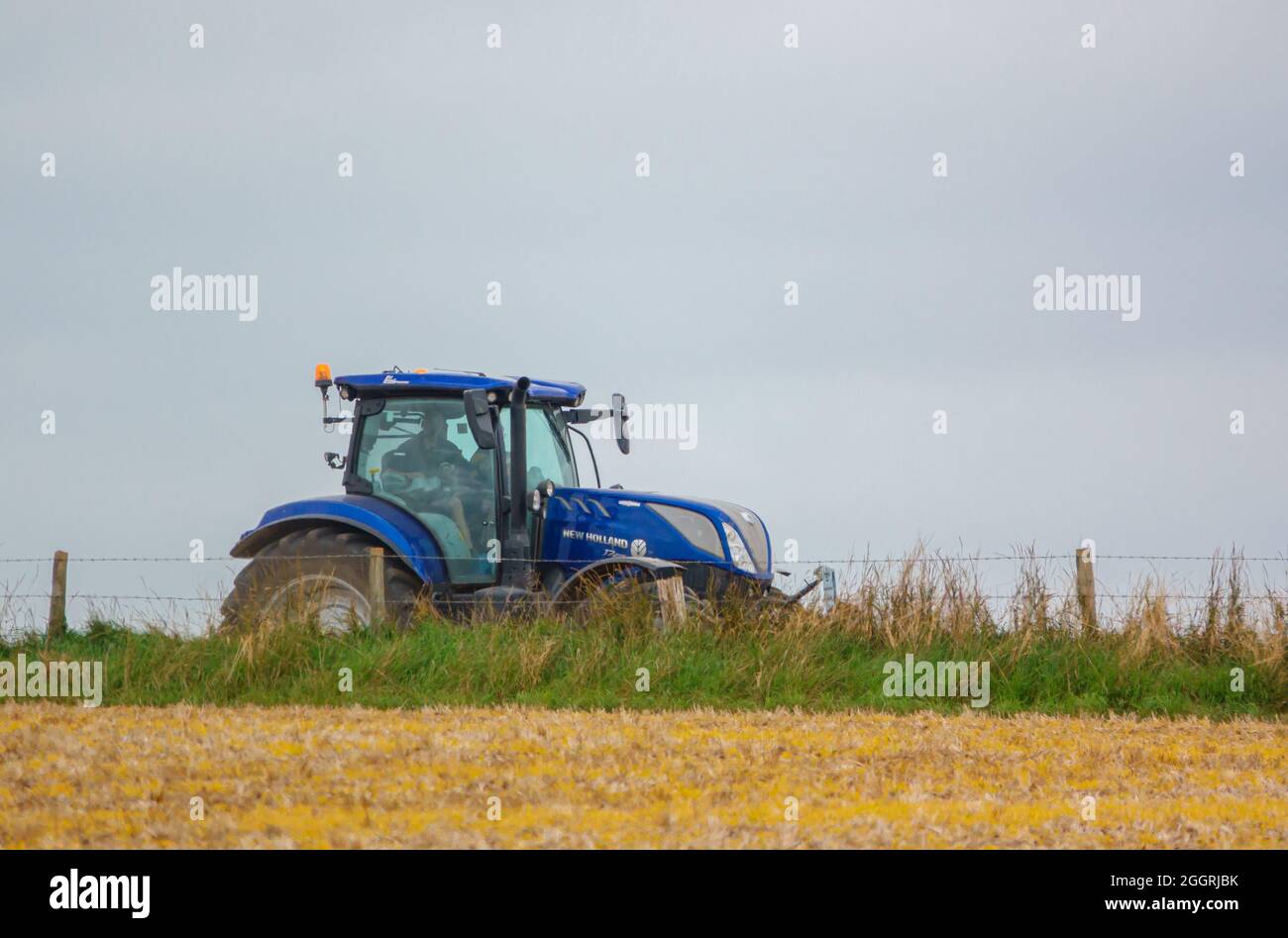New Holland T7 225 tractor in action Stock Photo - Alamy