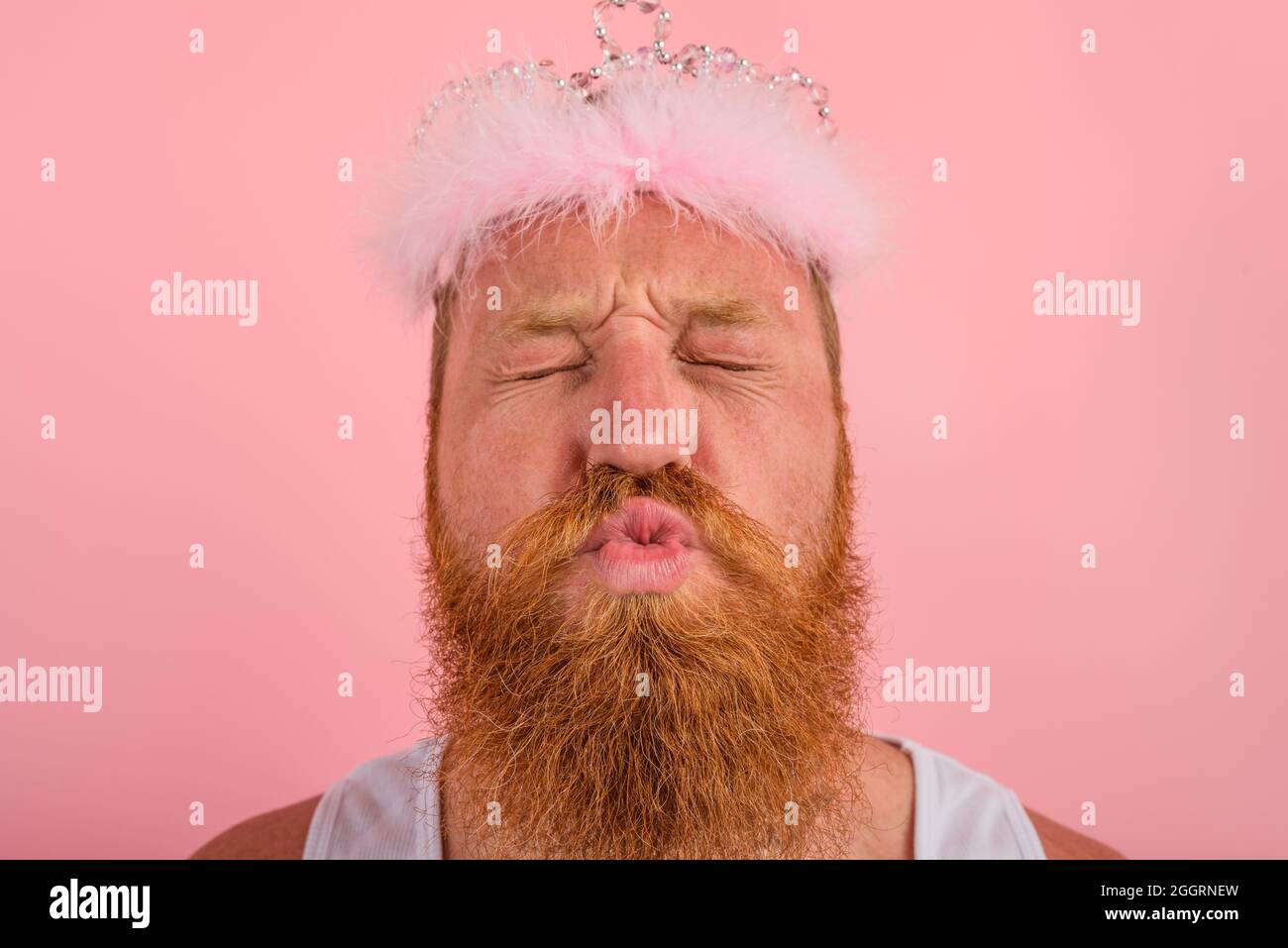man with beard , tattoos and crown acts like a princess Stock Photo - Alamy