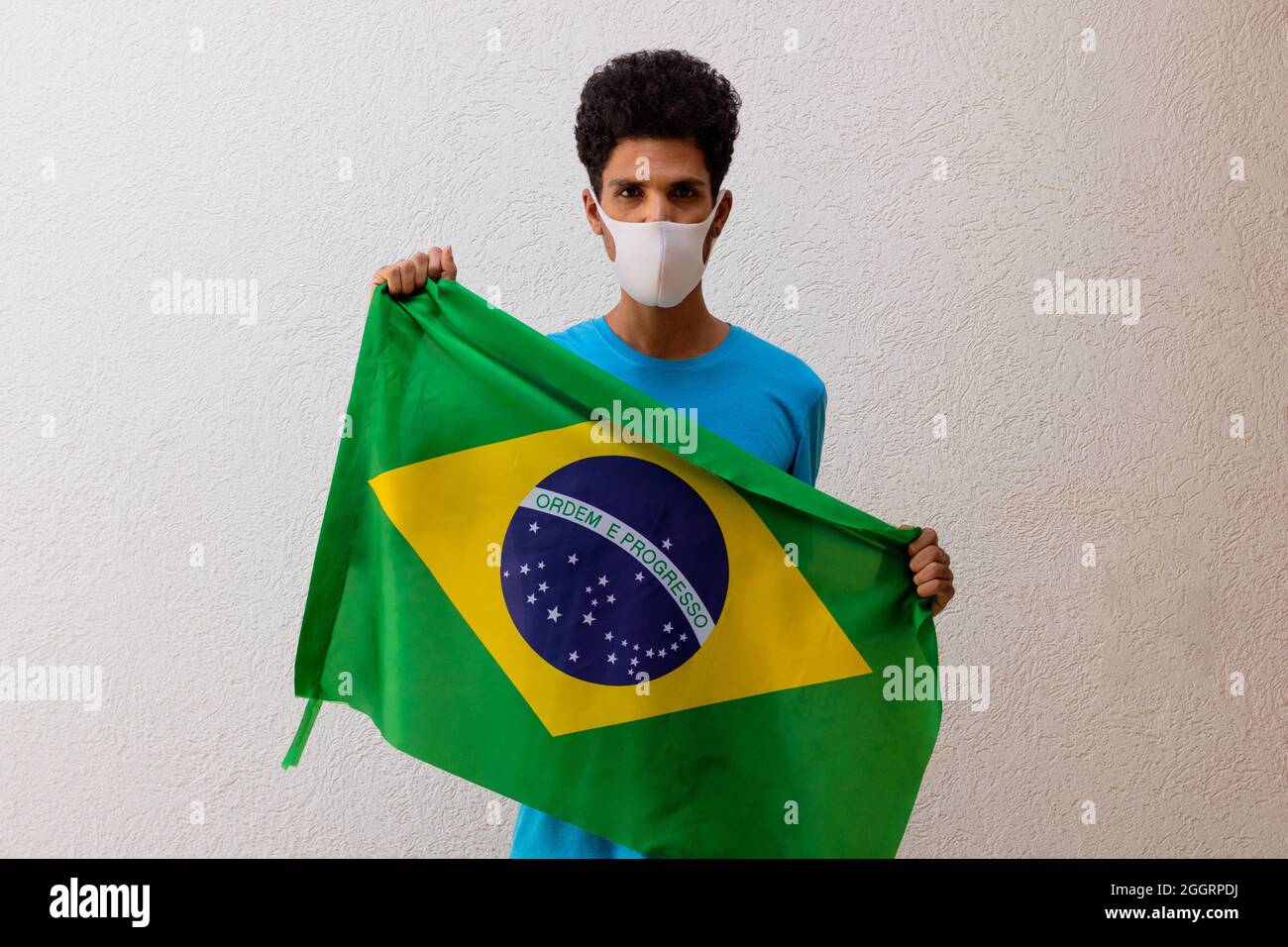 Black Man With Pandemic Mask Holding a Brazil Flag Isolated On White ...