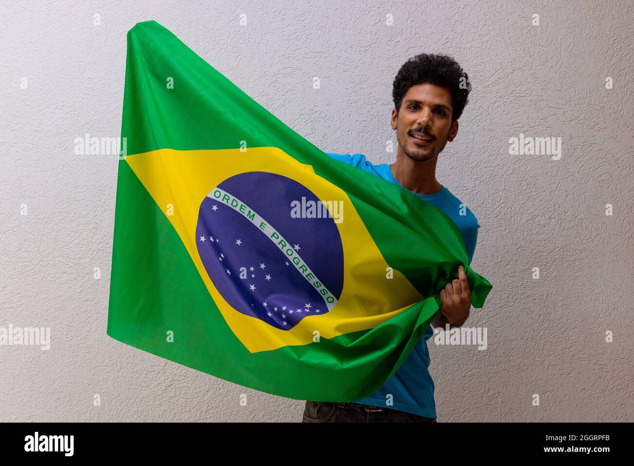 Black Man Holding a Brazil Flag Isolated On White Stock Photo - Alamy