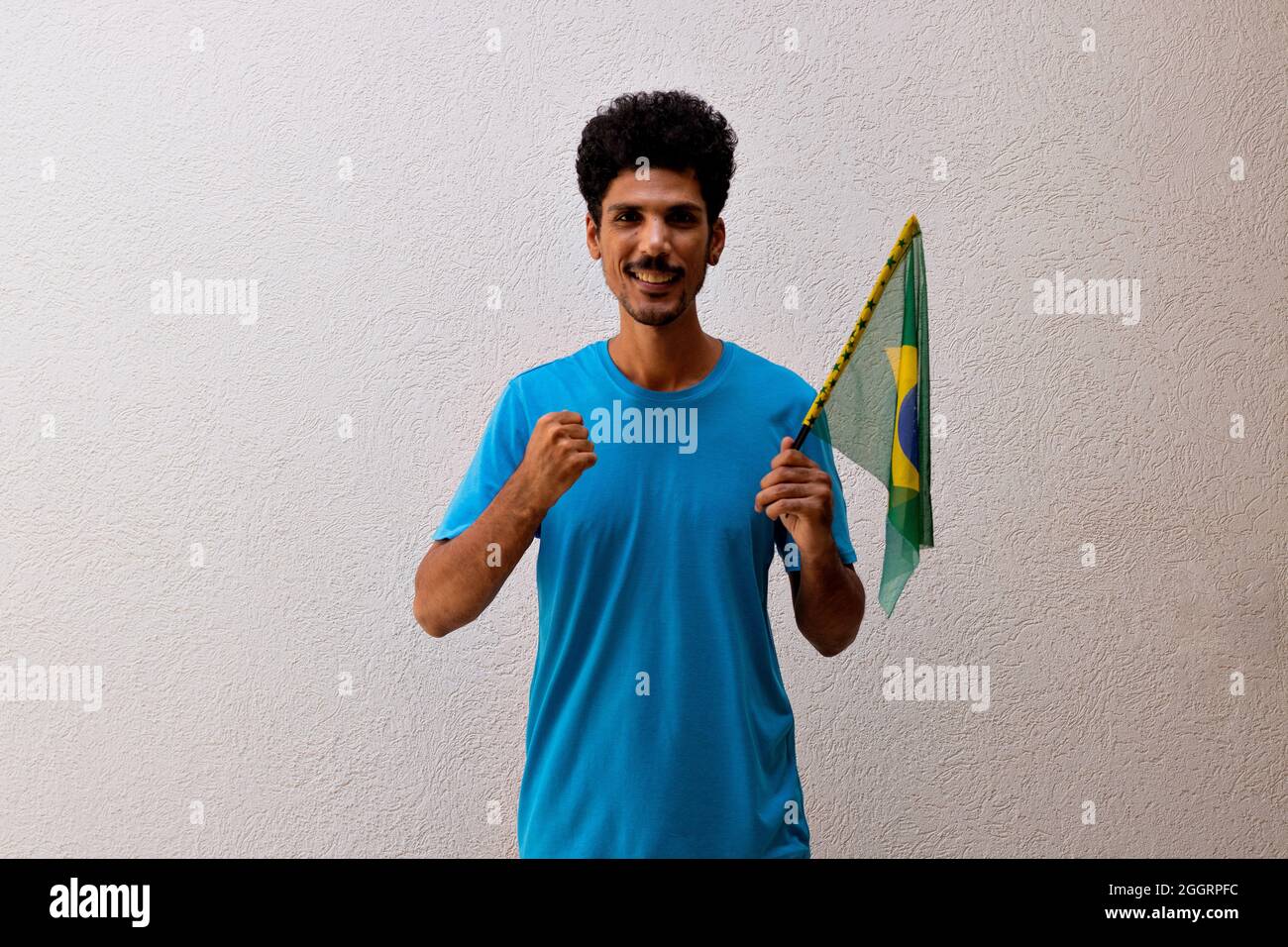 Black Man Holding a Brazil Flag Isolated On White Stock Photo - Alamy