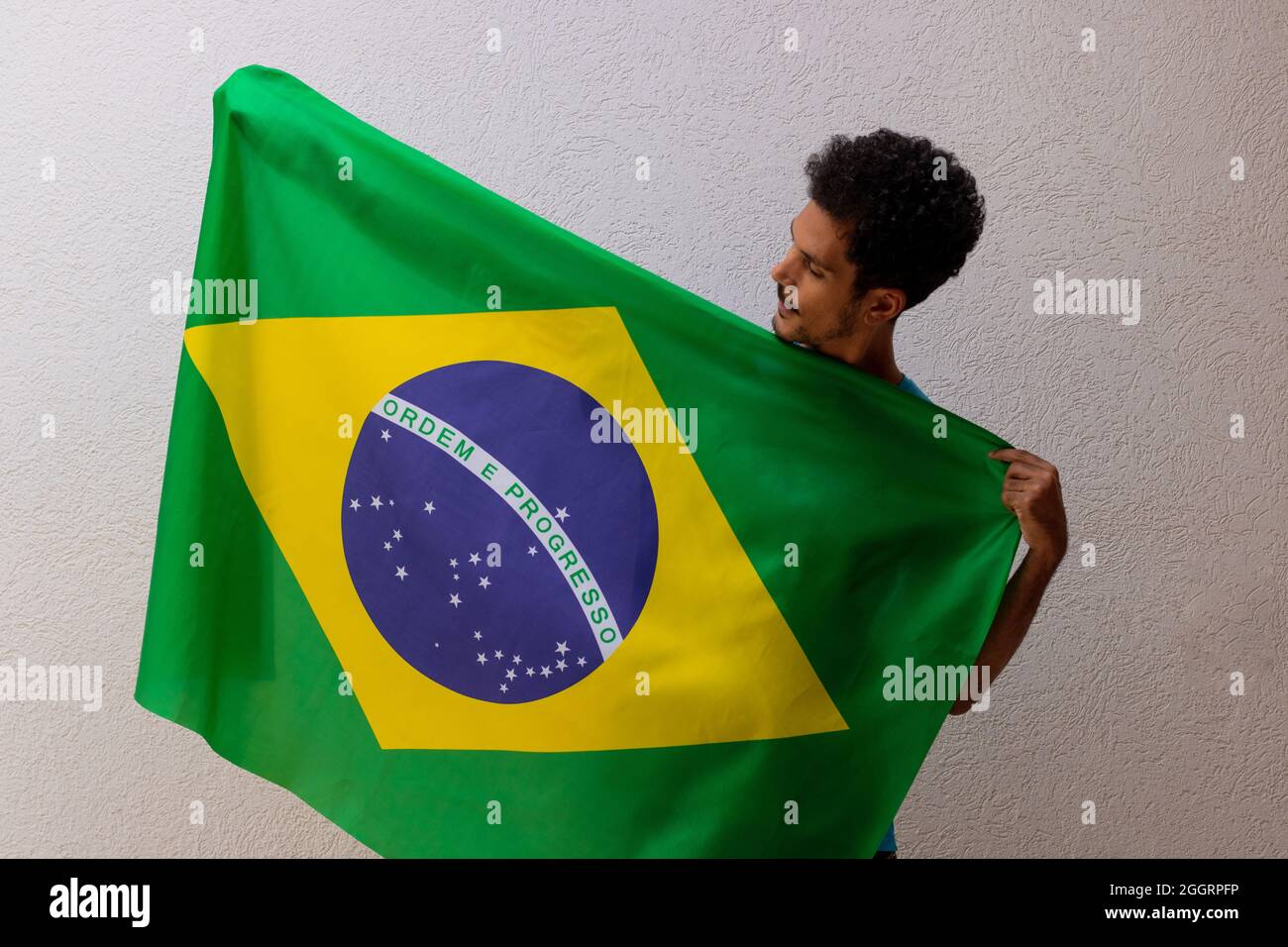 Black Man Holding a Brazil Flag Isolated On White Stock Photo - Alamy