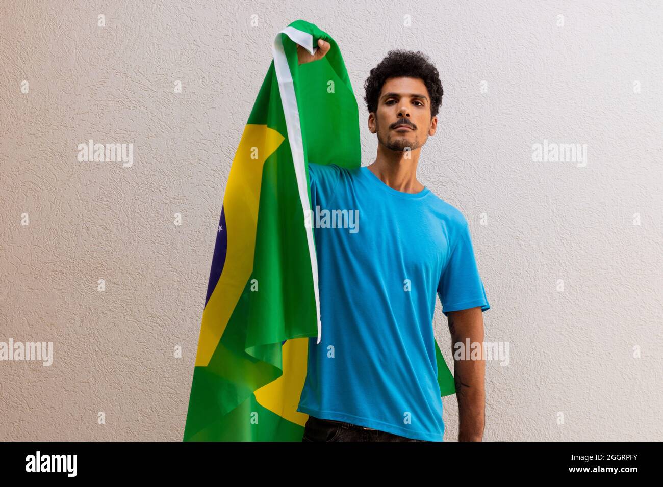 Black Man Holding a Brazil Flag Isolated On White Stock Photo - Alamy