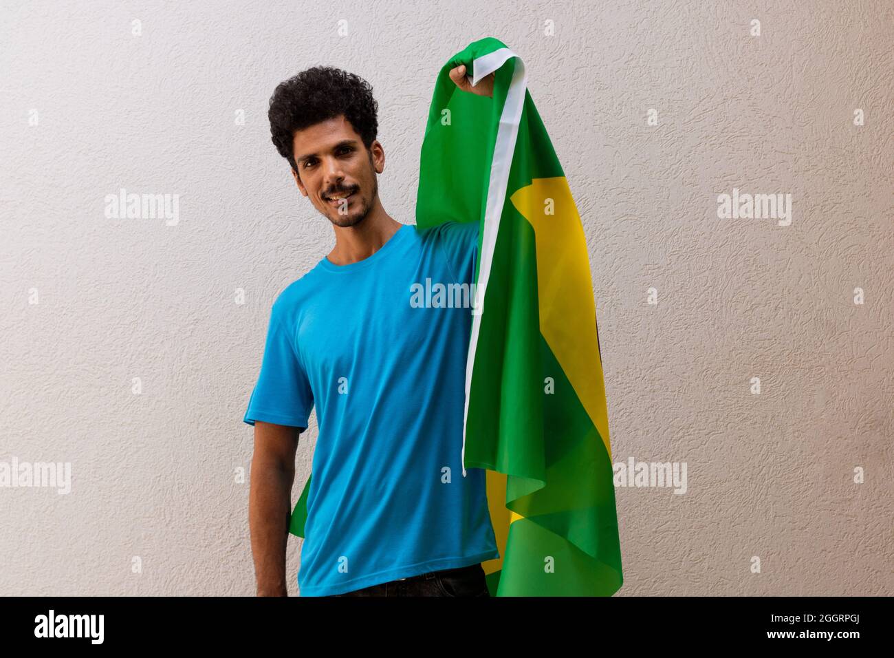 Black Man Holding a Brazil Flag Isolated On White Stock Photo - Alamy