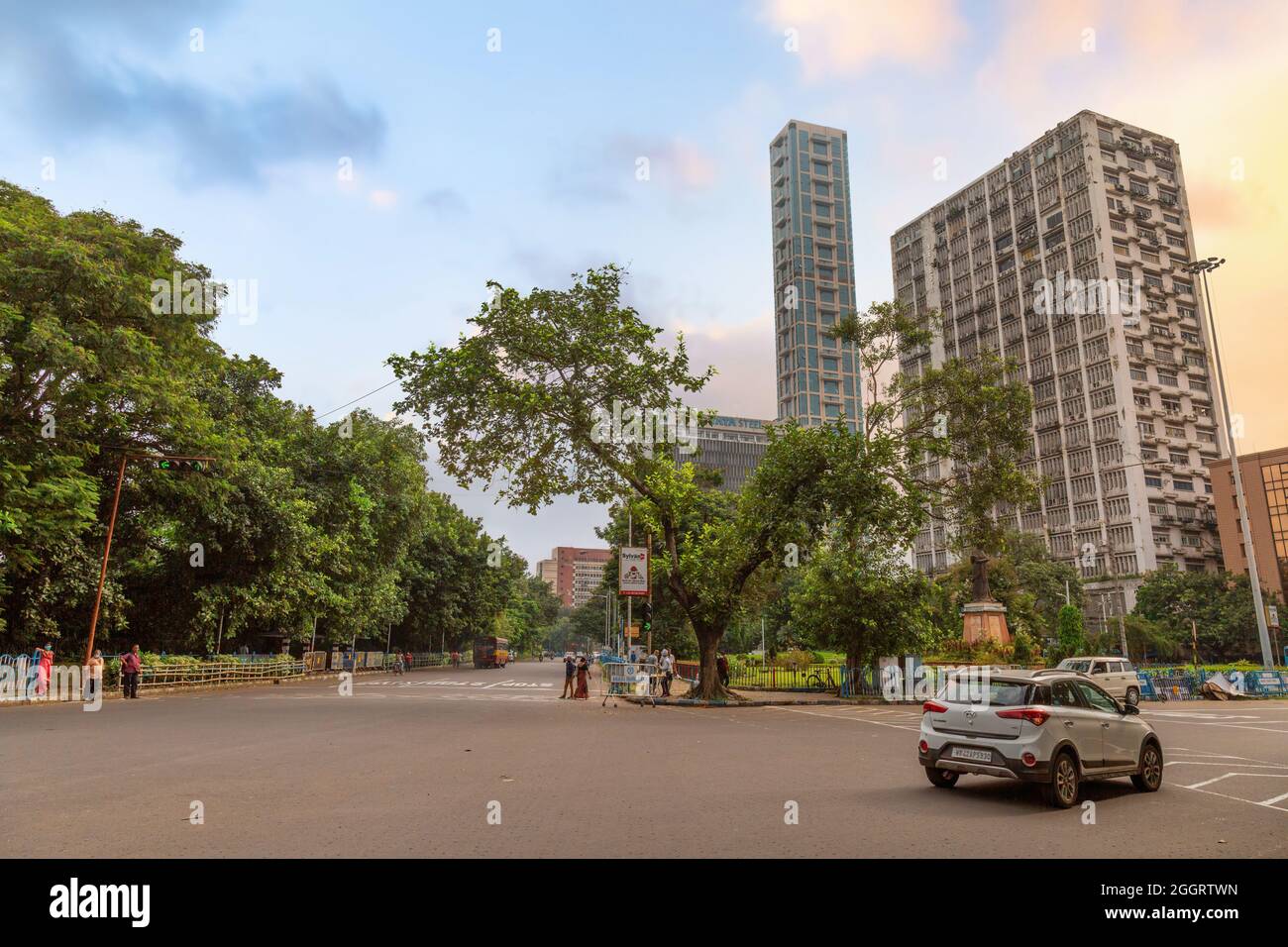 High rise commercial buildings with early morning traffic on city road ...