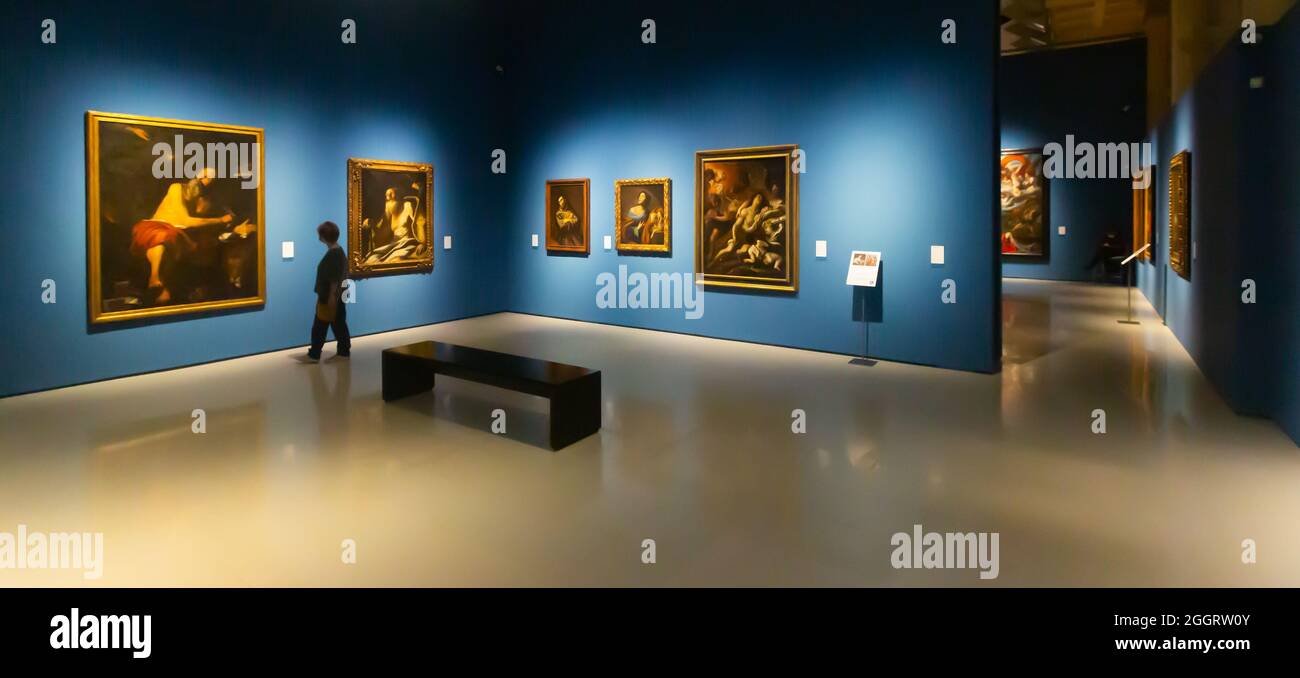 Hall of National Art Museum of Catalonia with visitors contemplating ...