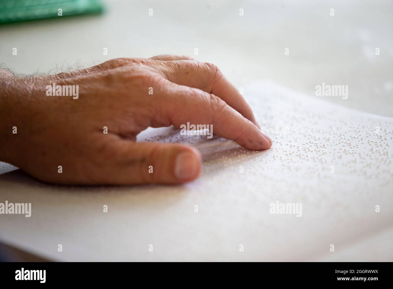 Detail of fingers reading a book in braille. Reading for the disabled ...