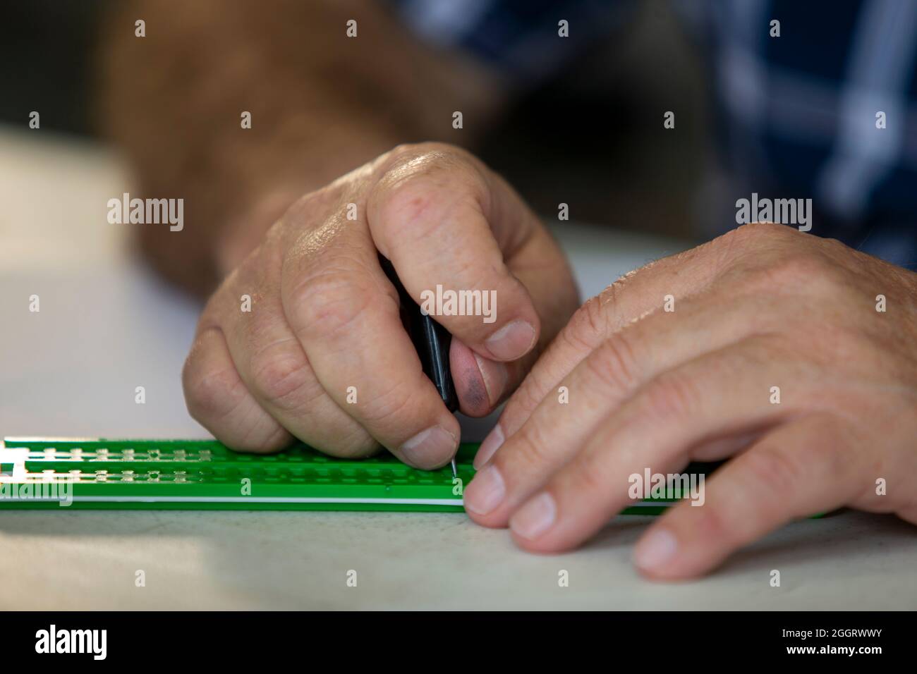 disabled person using a ruler to write in braille.Braille writing Stock ...