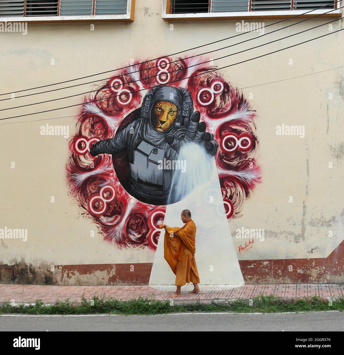A Buddhist Monk Walks Past a Mural in Lampang, Thailand Stock Photo - Alamy