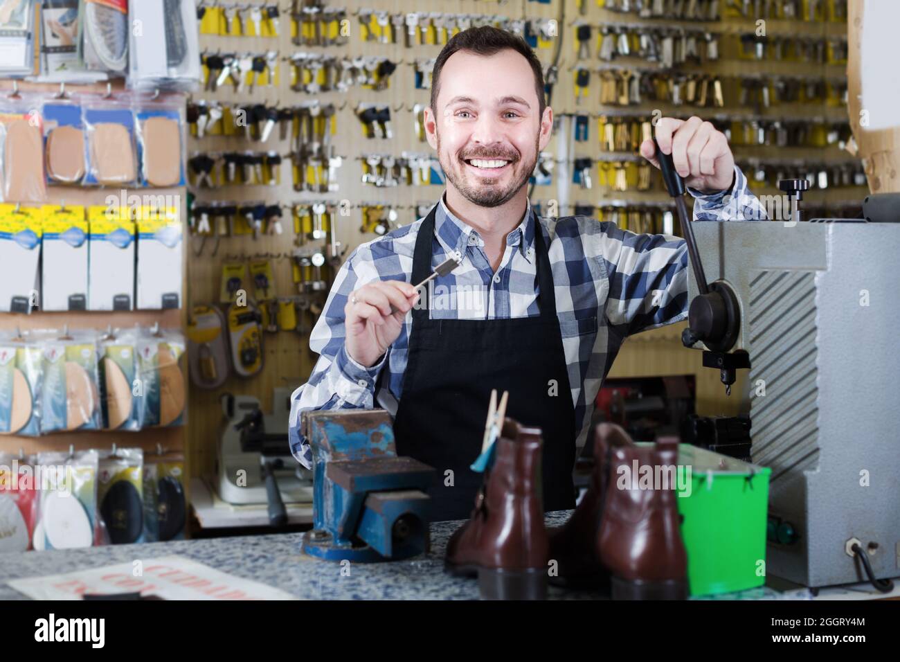 Male worker demonstrating his tools for making keys Stock Photo - Alamy