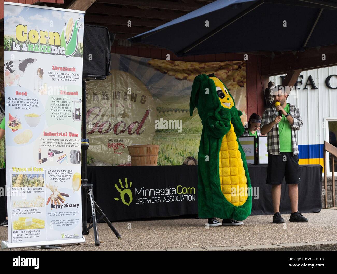 A man and a person in a corn costume give a presentation on corn, at ...