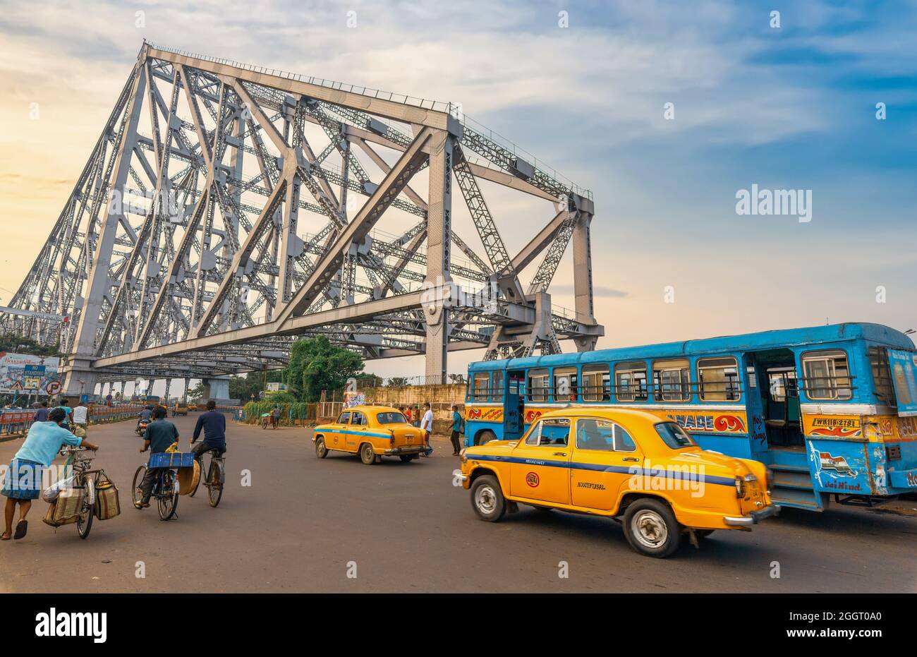 City traffic on Howrah bridge with view of public transport vehicles ...