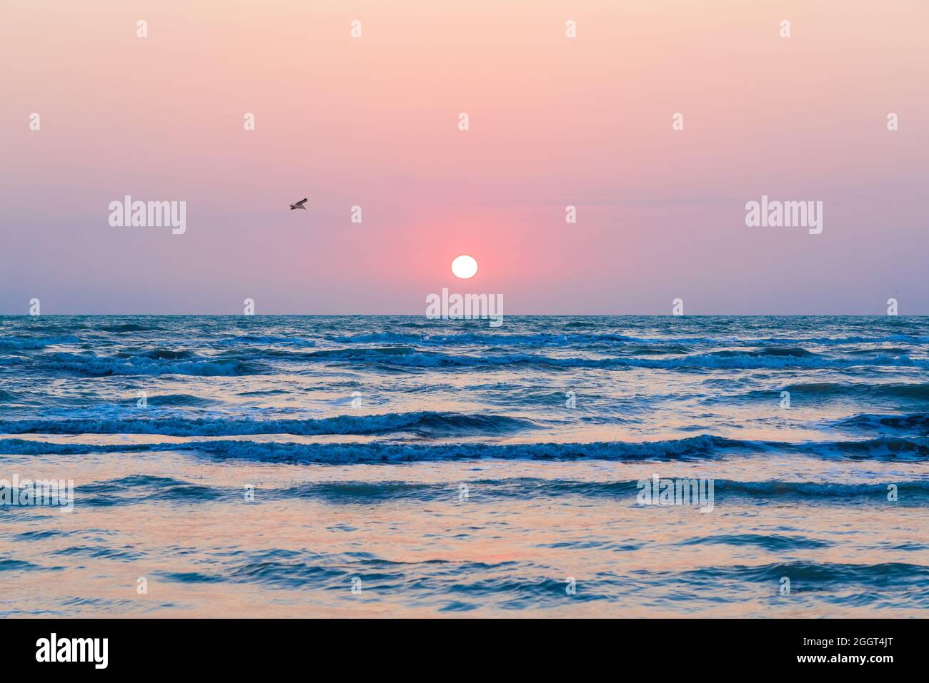Colorful sunrise by the ocean Stock Photo - Alamy