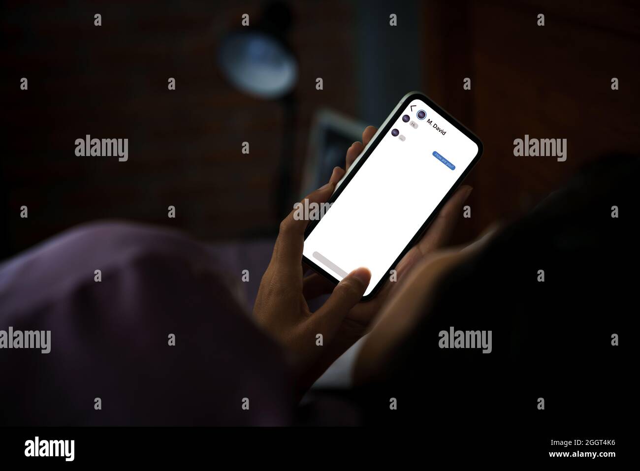 women using phone texting social on bed at night Stock Photo - Alamy