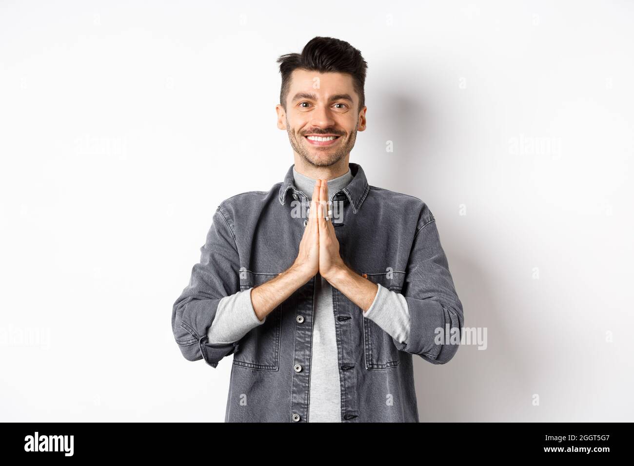 Thank you. Smiling friendly guy showing namaste gesture in gratitude ...