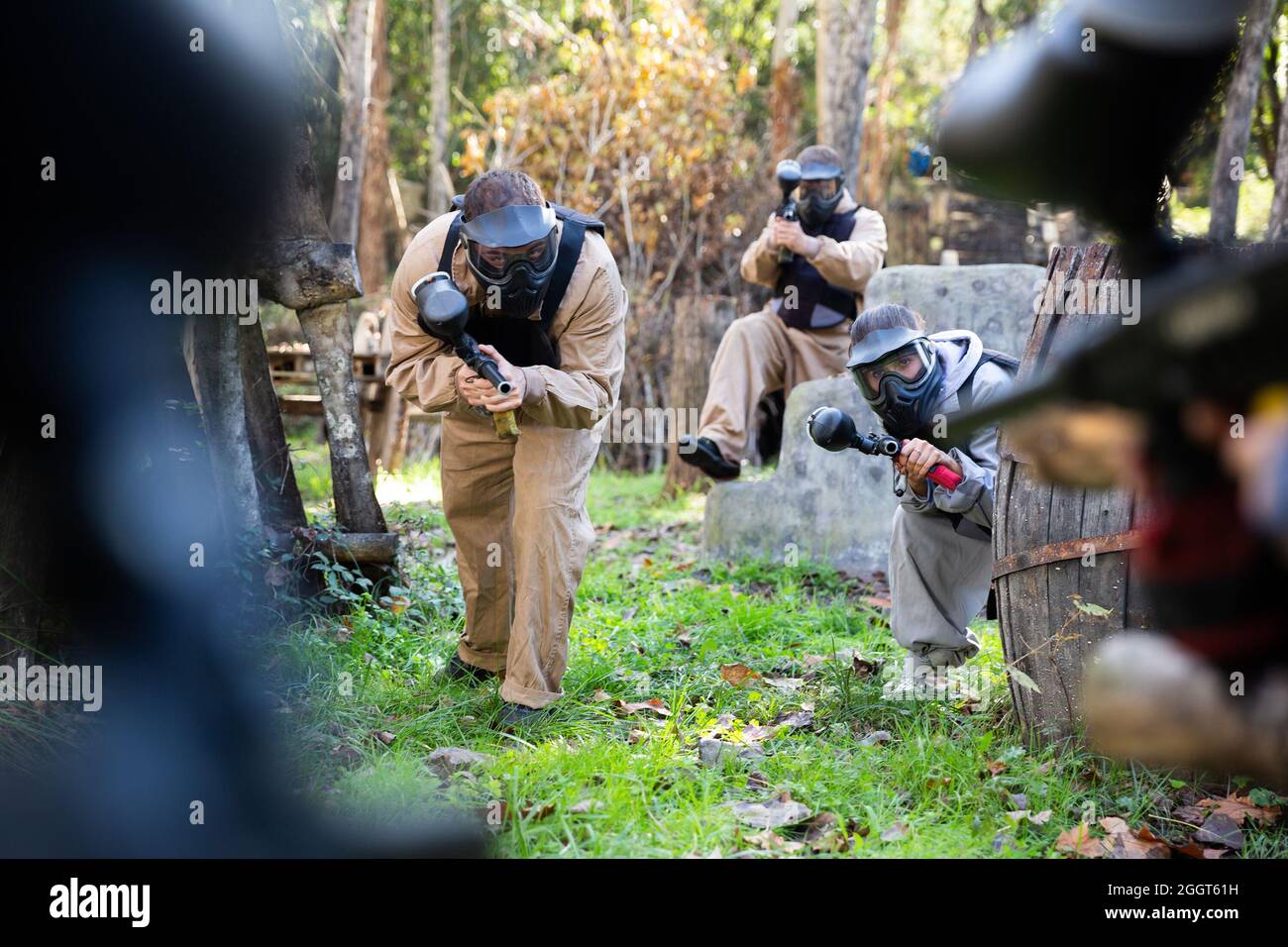 People playing paintball outdoors Stock Photo - Alamy