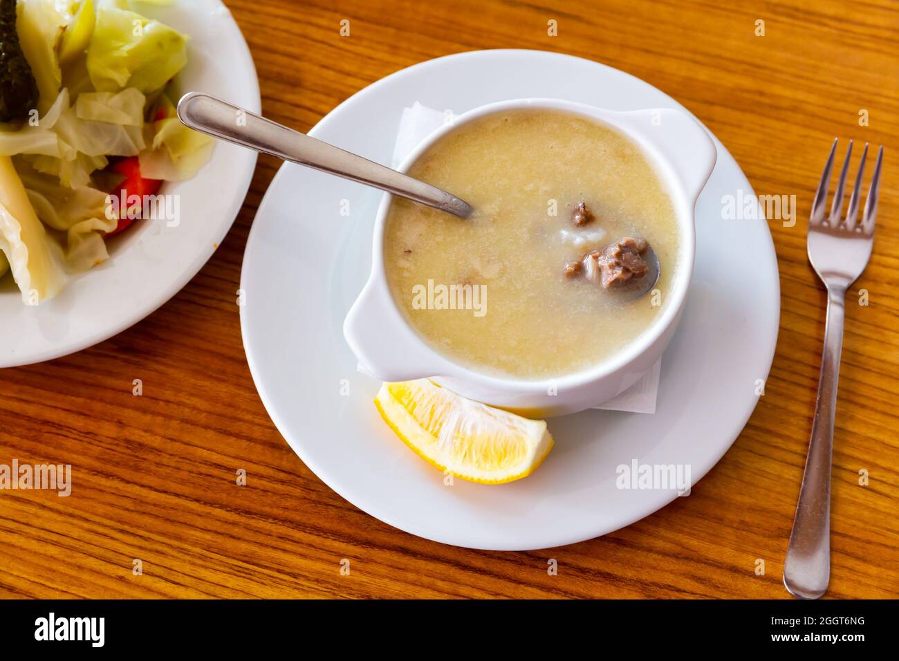 Turkish soup Paca corbasi served with pickle vegetables Stock Photo - Alamy