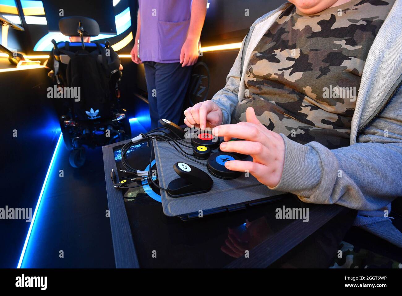EDITORIAL USE ONLY A child uses an adaptive controller to play video ...