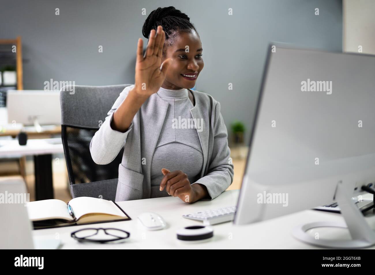 Virtual Video Conference In Office Waving Hand Stock Photo - Alamy