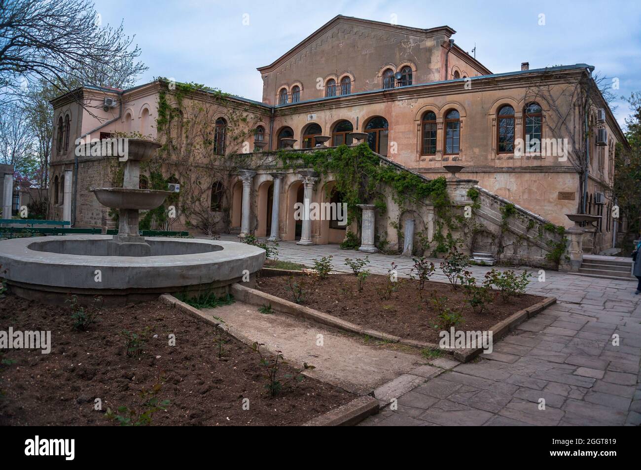 the ancient building is overgrown with greenery Stock Photo - Alamy