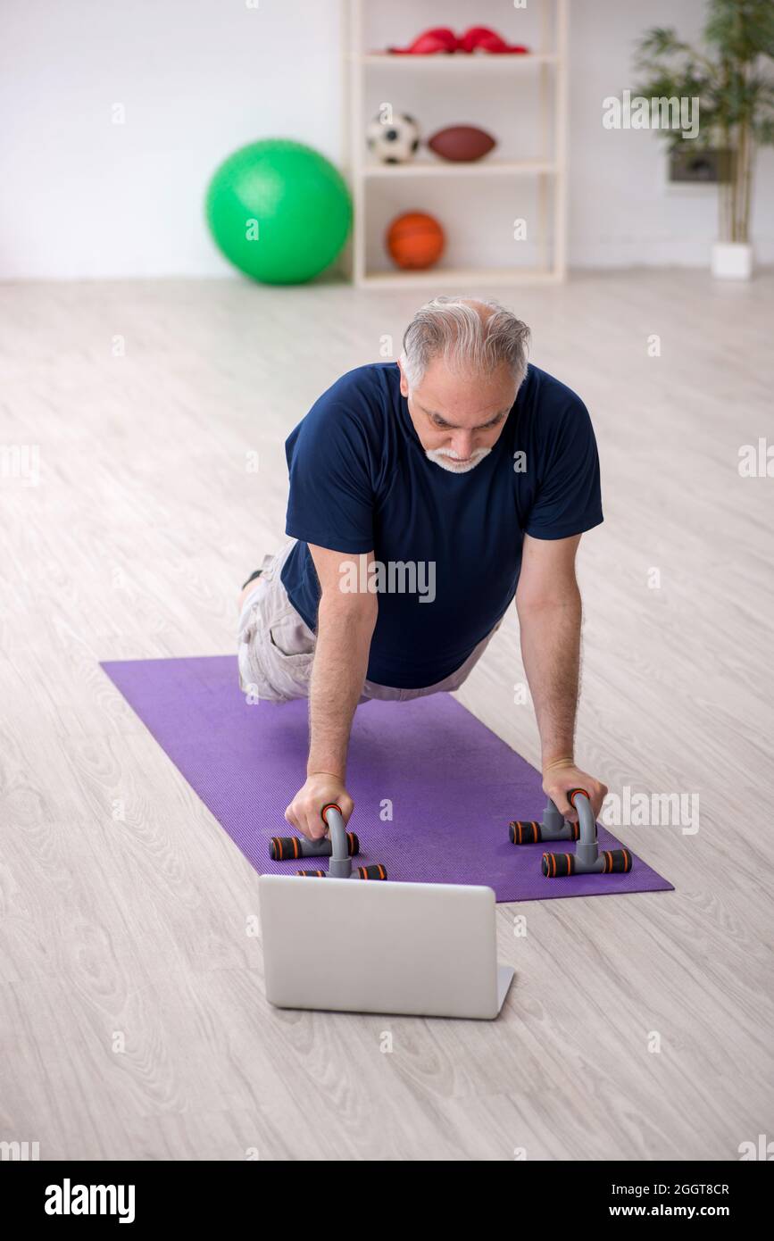 Old man doing sport exercises at home Stock Photo - Alamy