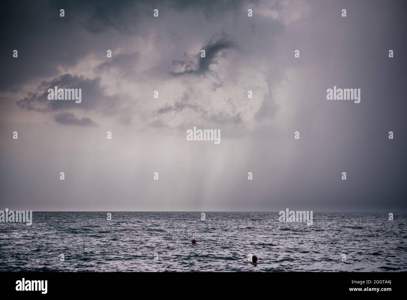 Dark rainy clouds over the sea surface landscape Stock Photo - Alamy