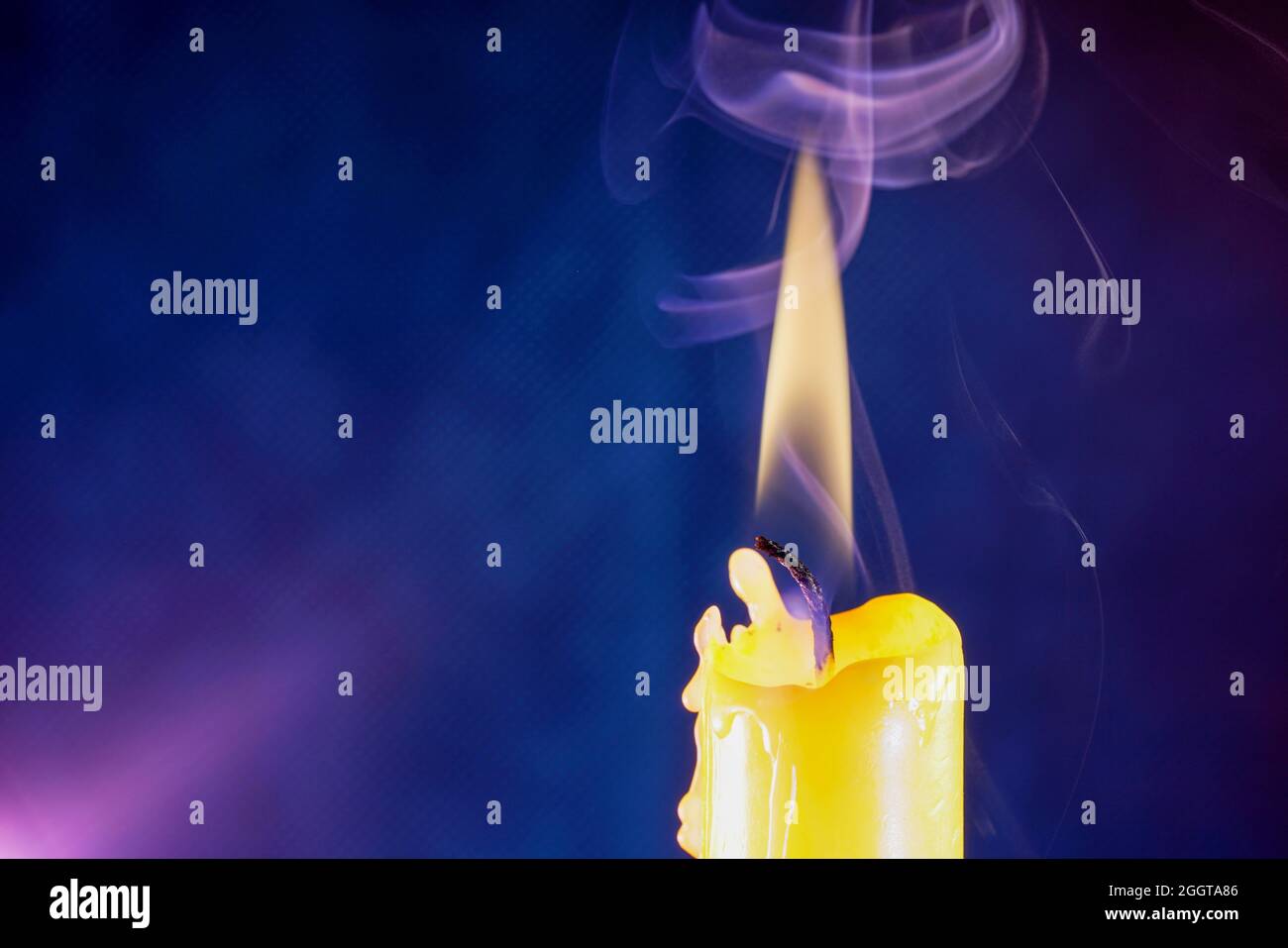 Candle with smoke and flame as a background with structure and copy ...