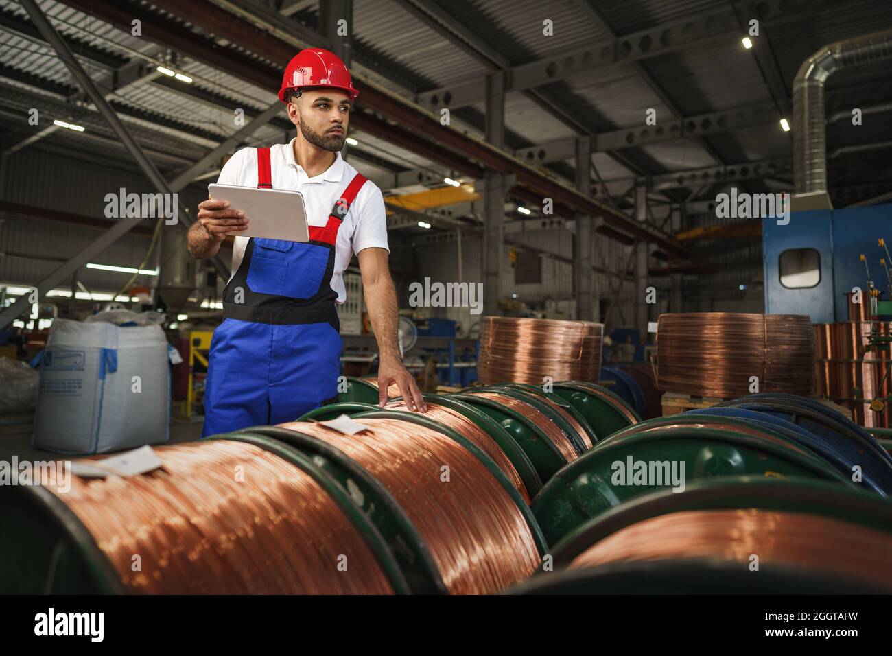 African american male manager in electric cable warehouse holding ...