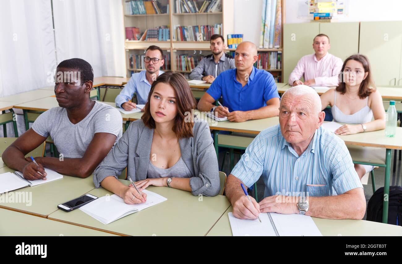 Students mixed age take a written exam Stock Photo - Alamy