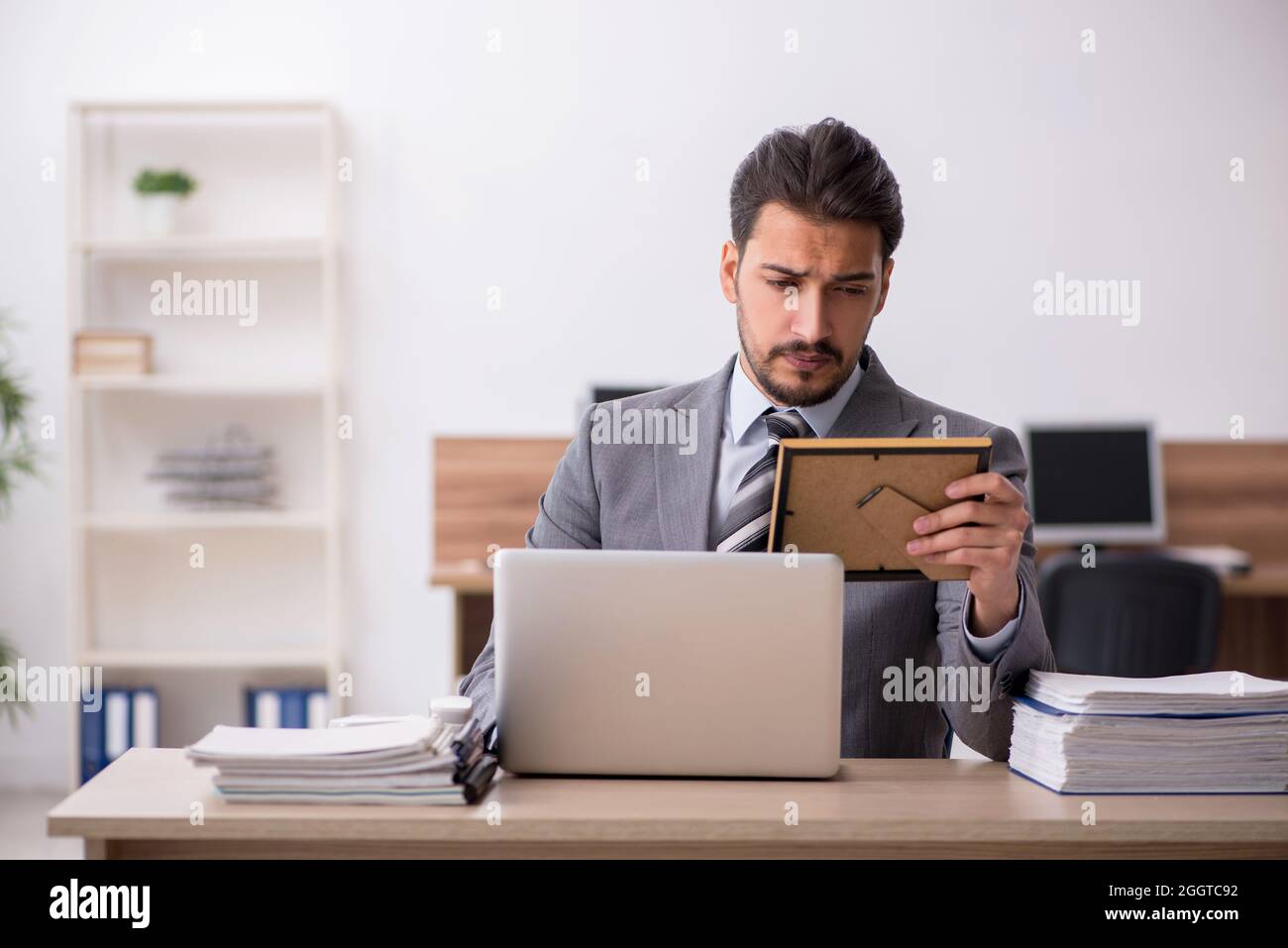 Young businessman employee missing girlfriend at workplace Stock Photo ...