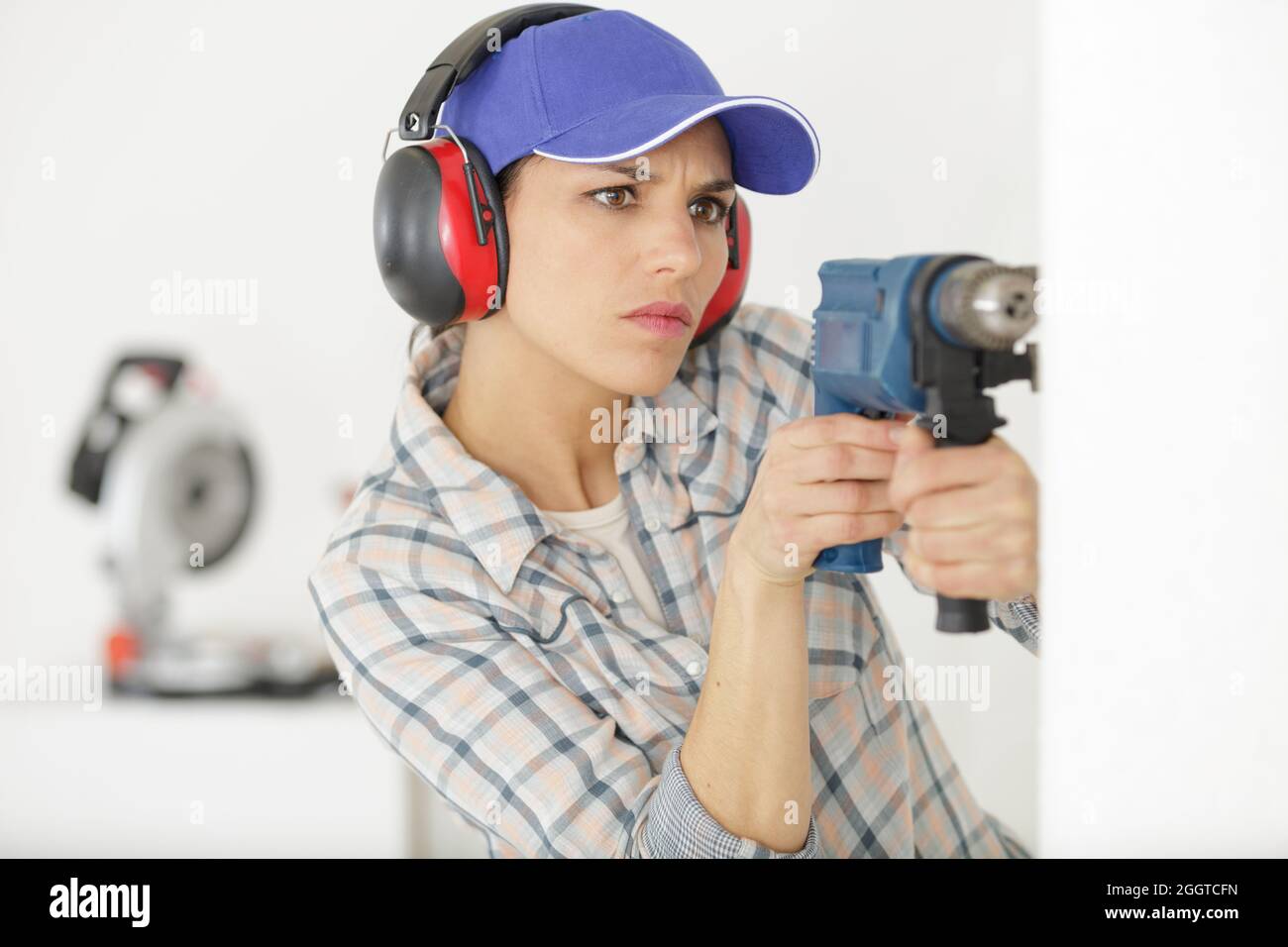 Attractive builder woman drill hi-res stock photography and images - Alamy