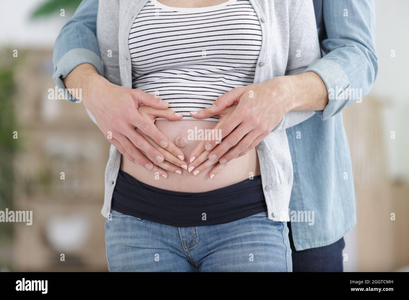 loving pregnant couple hugging the belly Stock Photo - Alamy