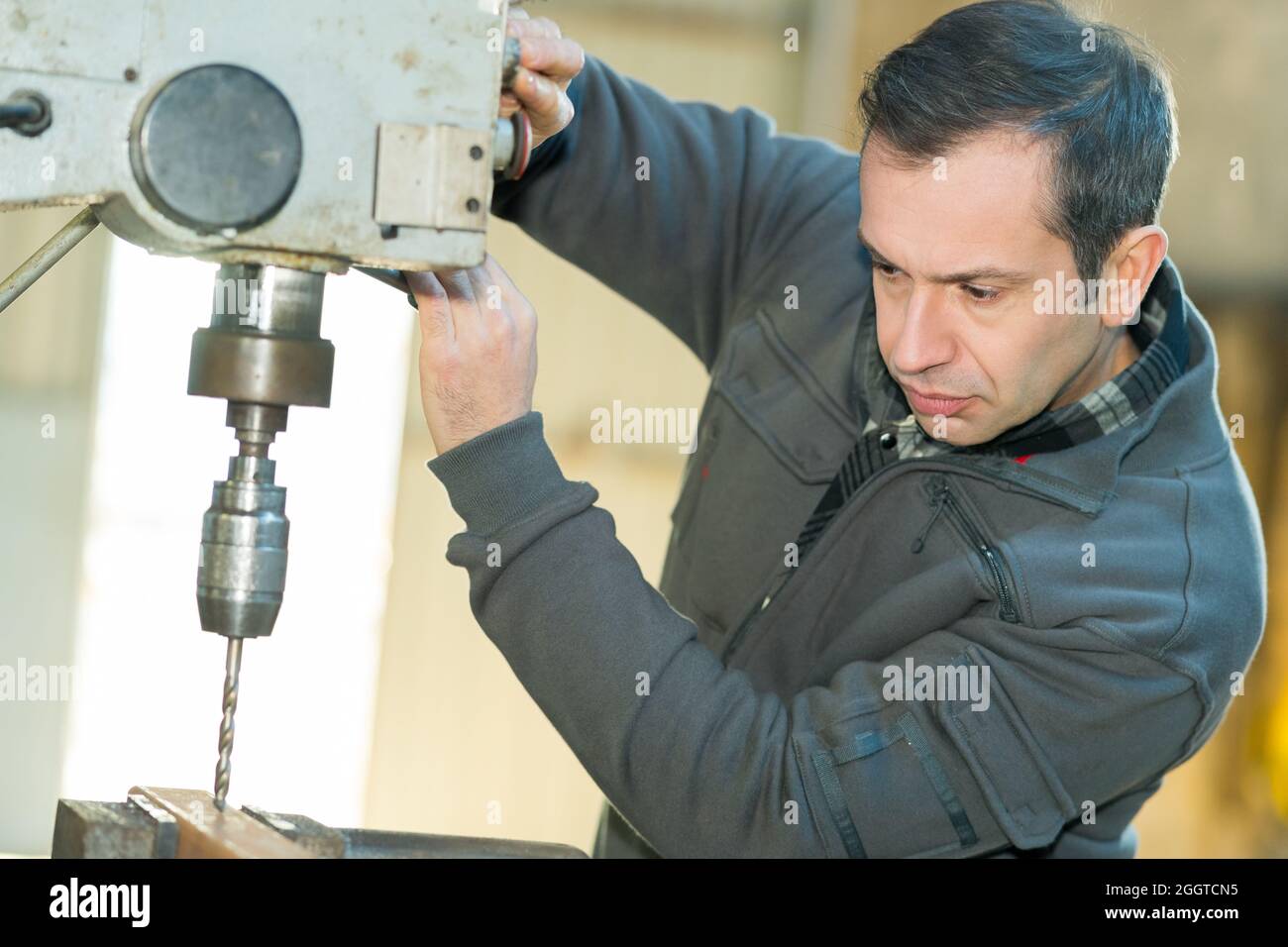 Workers operating automated industrial machine hi-res stock photography ...