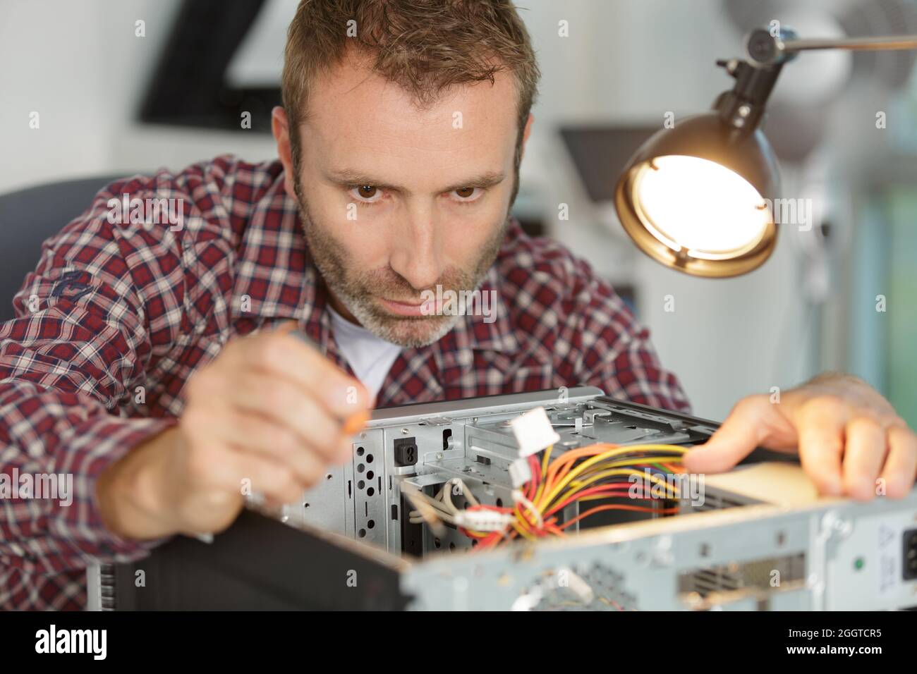 computer repairman on wheelchair working Stock Photo - Alamy