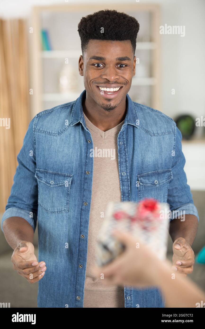 surprised man receiving a gift Stock Photo - Alamy