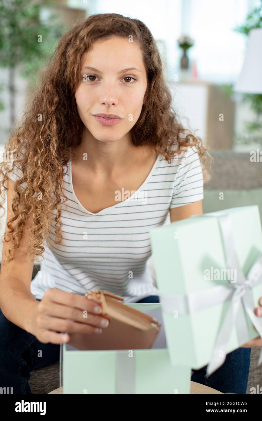 picture showing woman opening present on sofa Stock Photo - Alamy