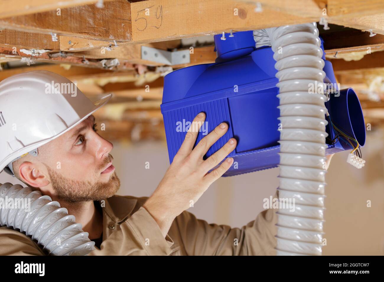 young builder with ventilation system Stock Photo - Alamy