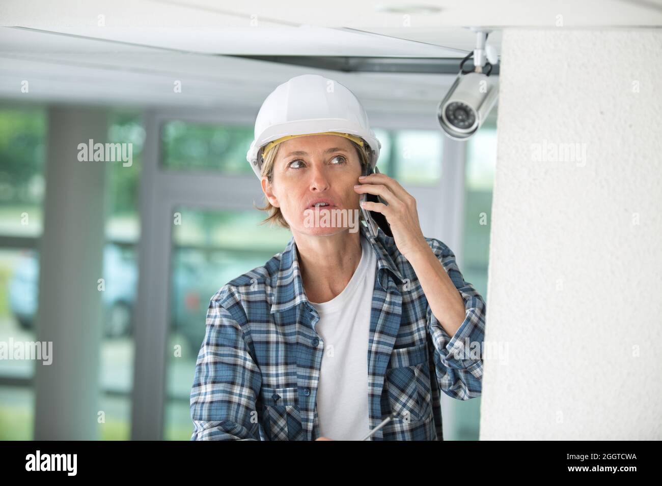 worker calling to report cctv problem Stock Photo - Alamy