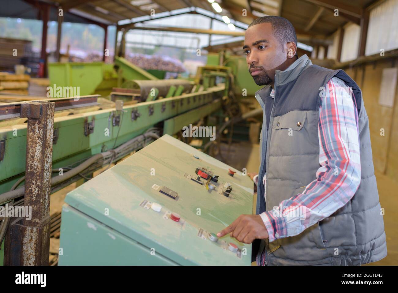 man operating machine at factory Stock Photo - Alamy