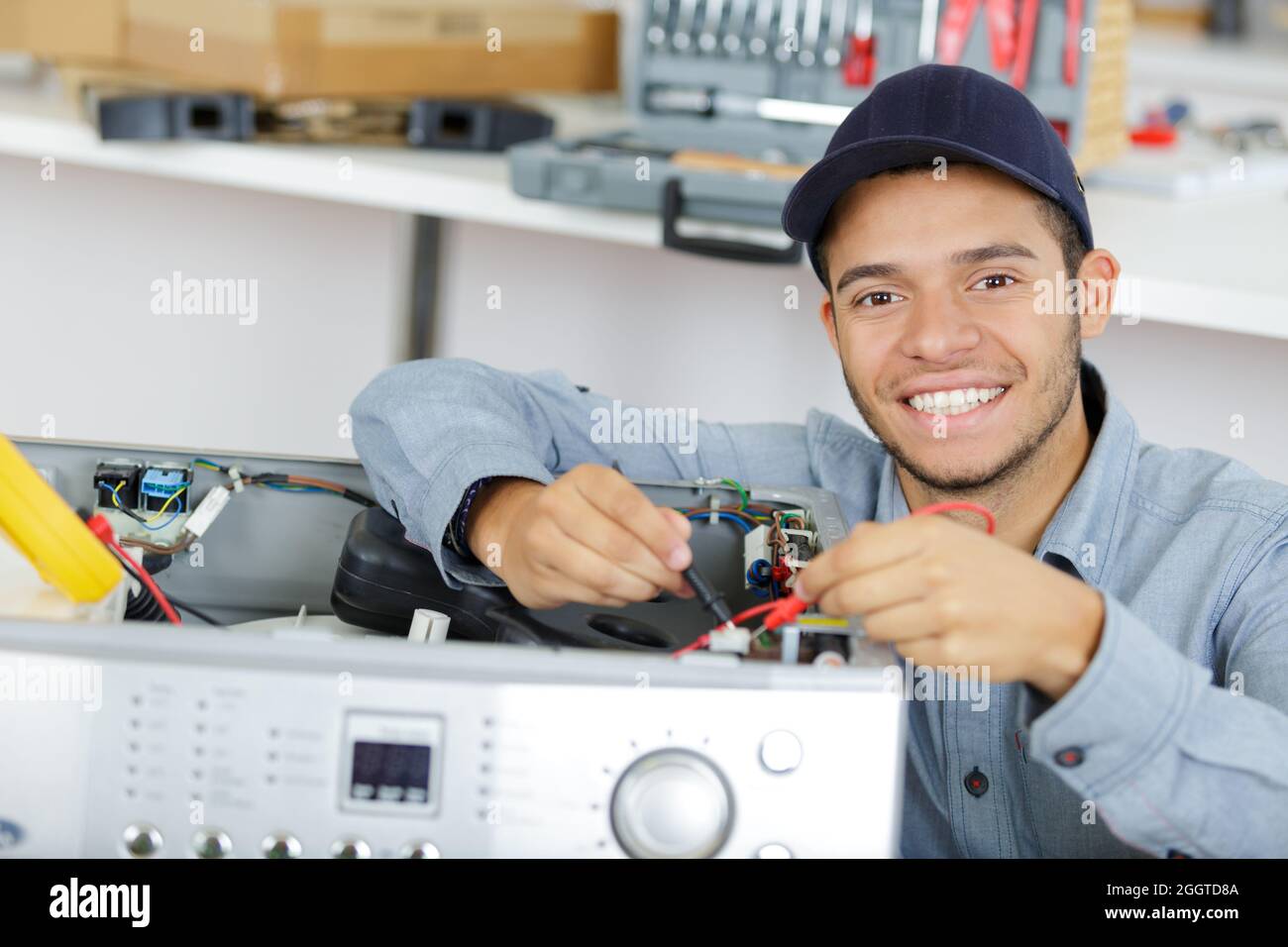 man fixing domestic washing machine Stock Photo - Alamy