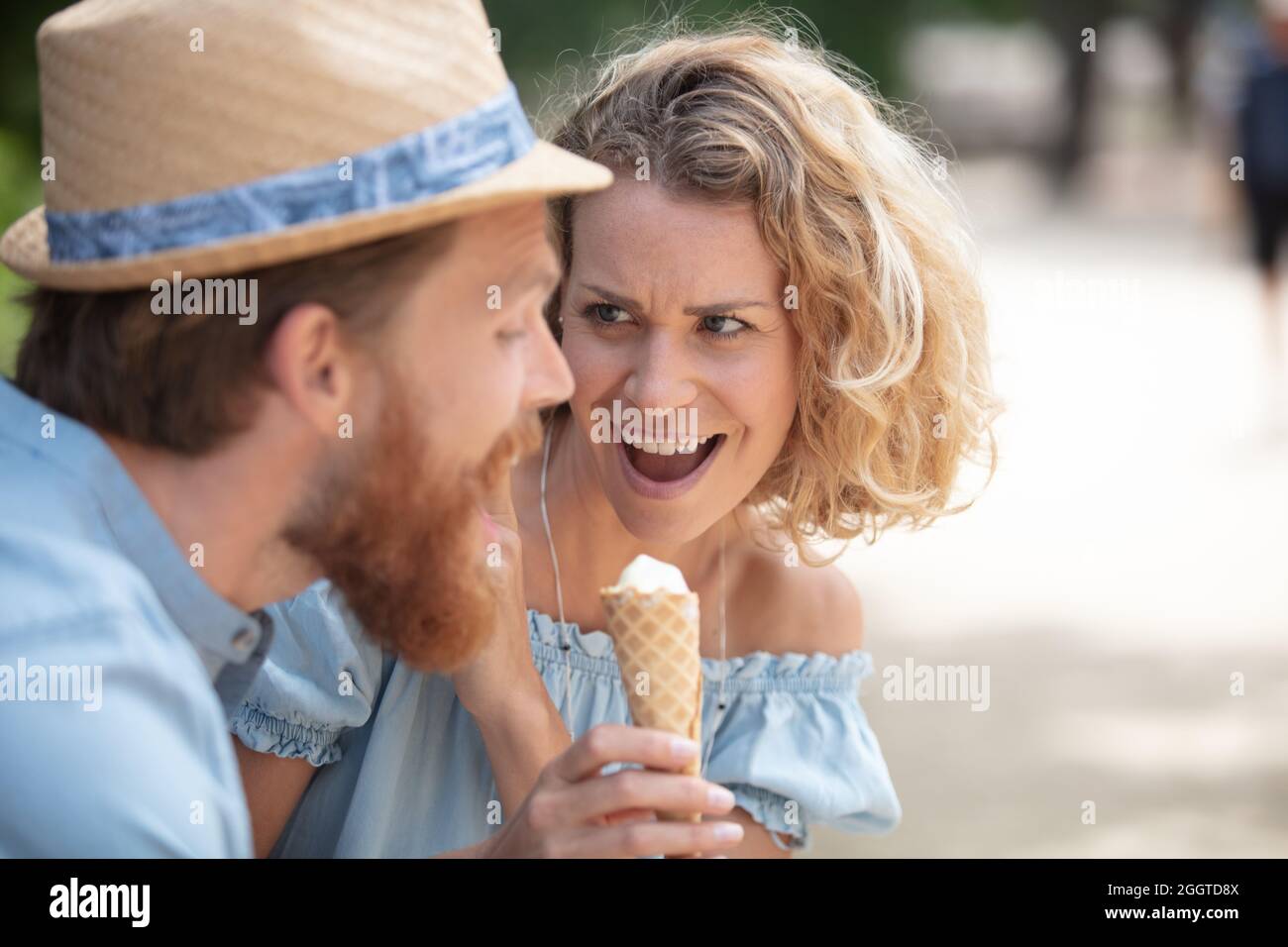 happy couple having date and eating ice cream Stock Photo - Alamy