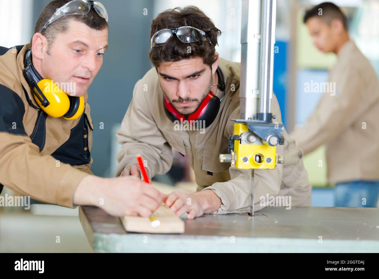 student and teacher sawing wood Stock Photo - Alamy