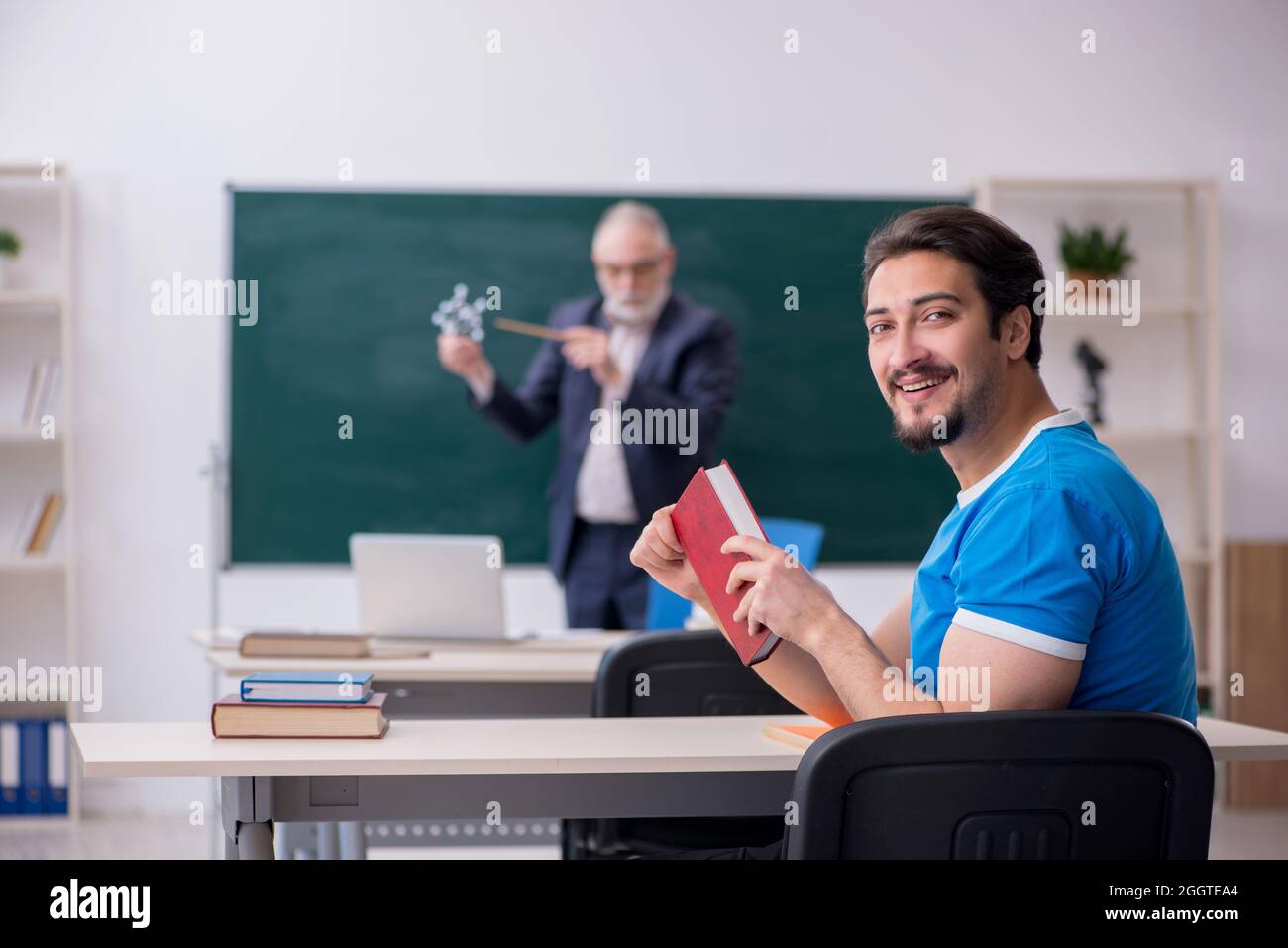 Old physics teacher and young male student in front of blackboard Stock ...