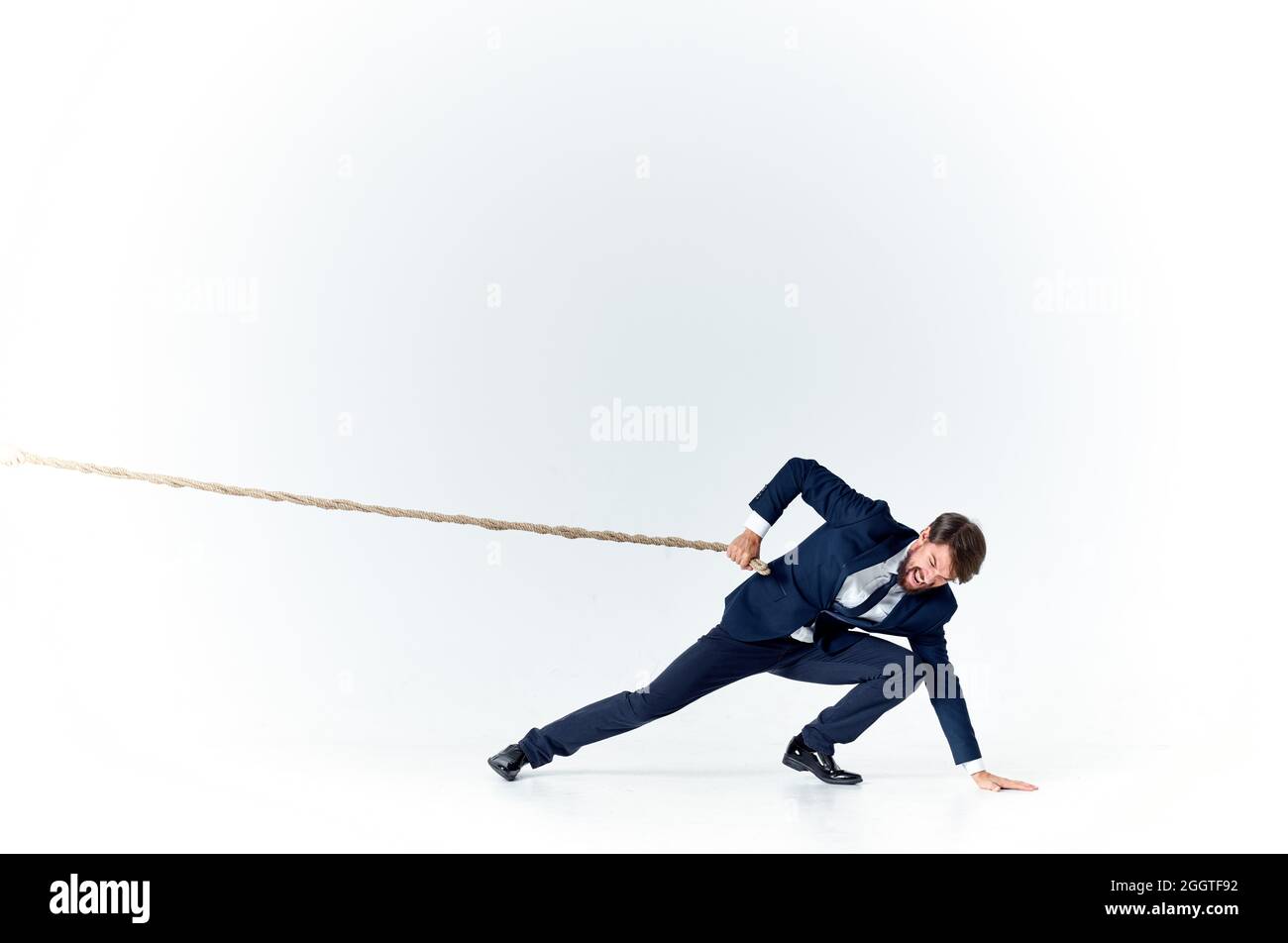 business man in suit pulling rope career office manager Stock Photo - Alamy