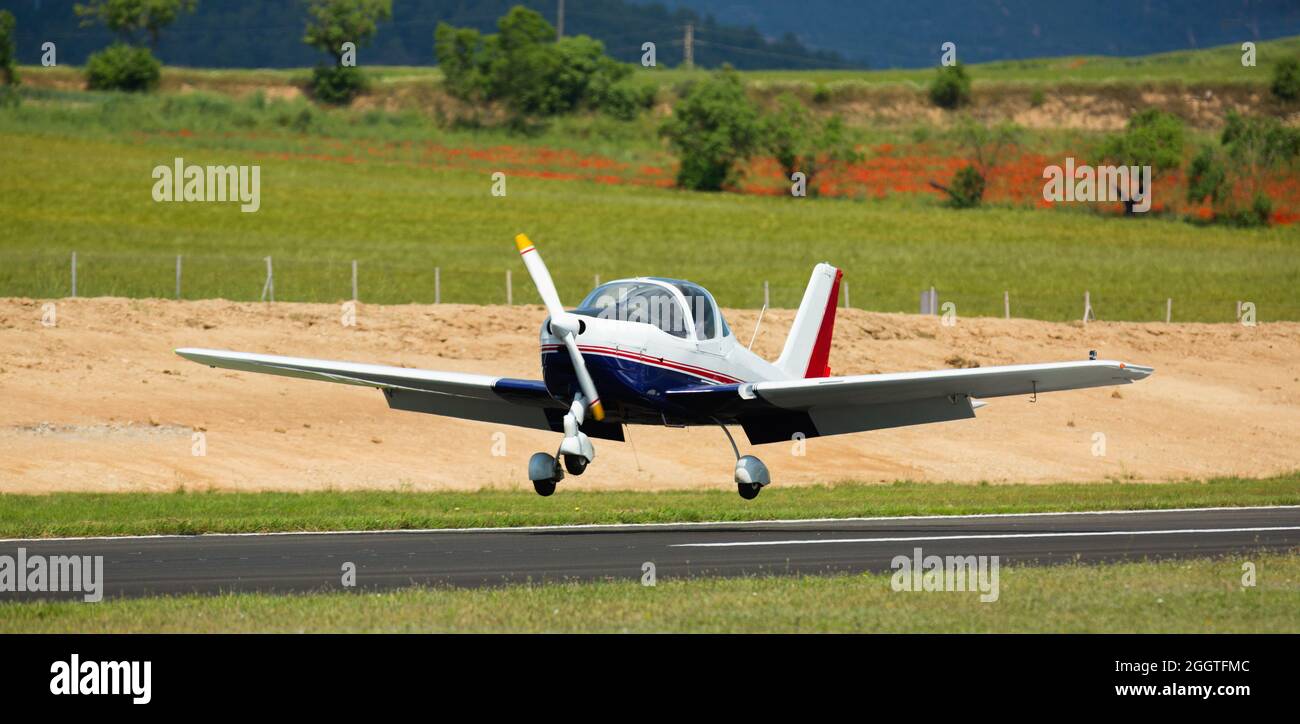 Light aircraft landing on aerodrome runway Stock Photo - Alamy