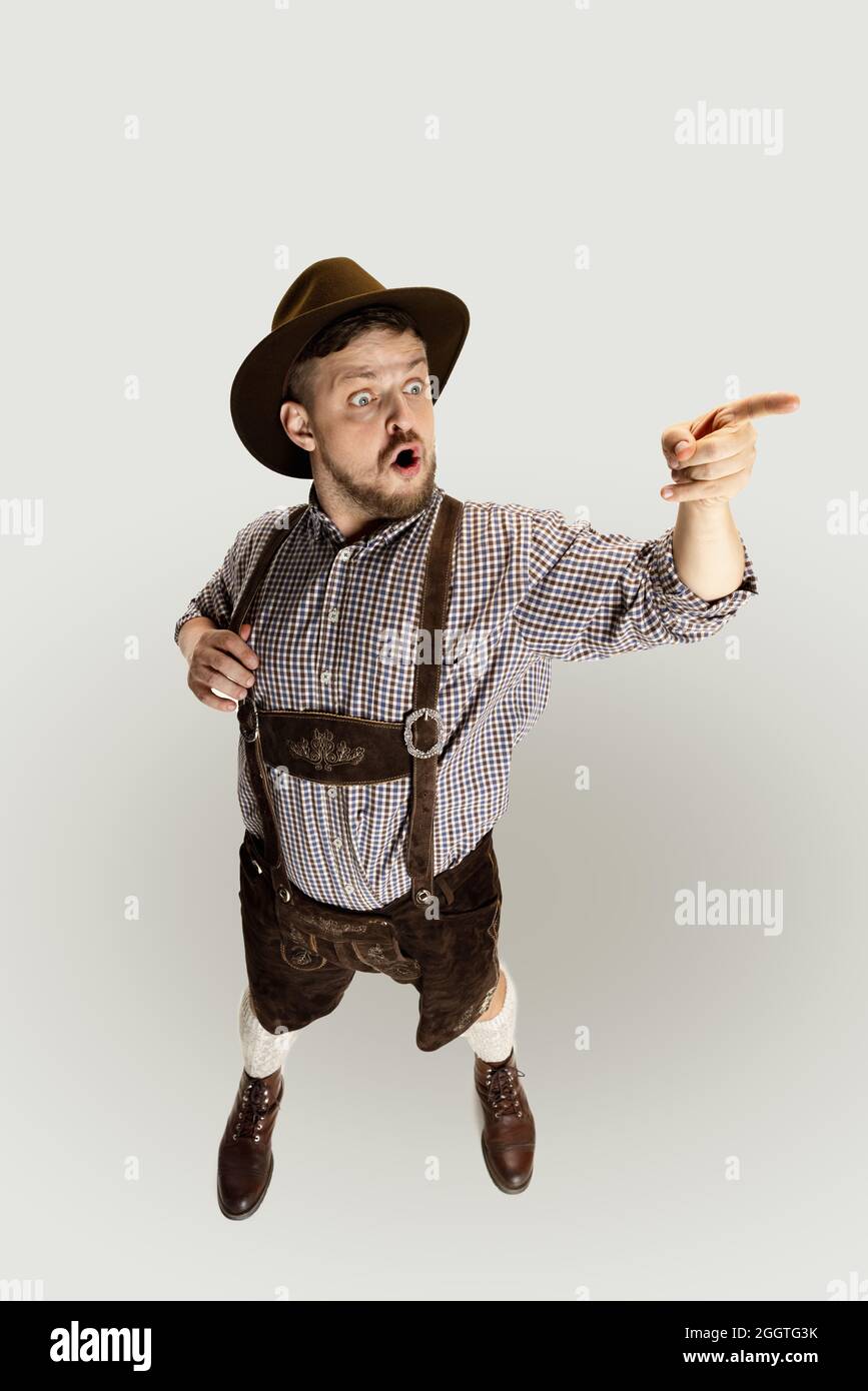 Cute surprised bearded man, waiter in traditional Austrian or Bavarian ...