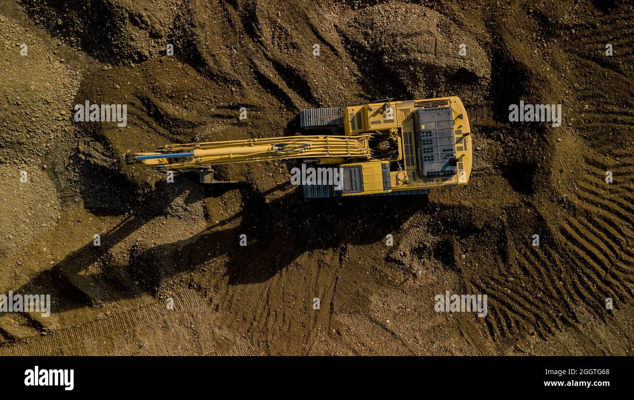 Aerial view of excavator pours sand. On the construction site top view ...